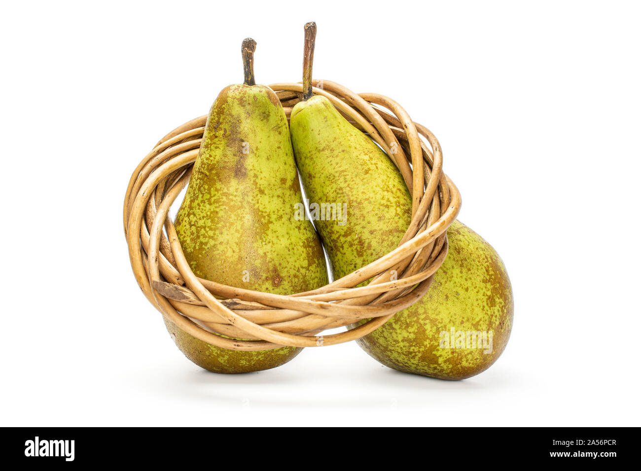 Group of two whole fresh green pear conference in wicker vine circle ...