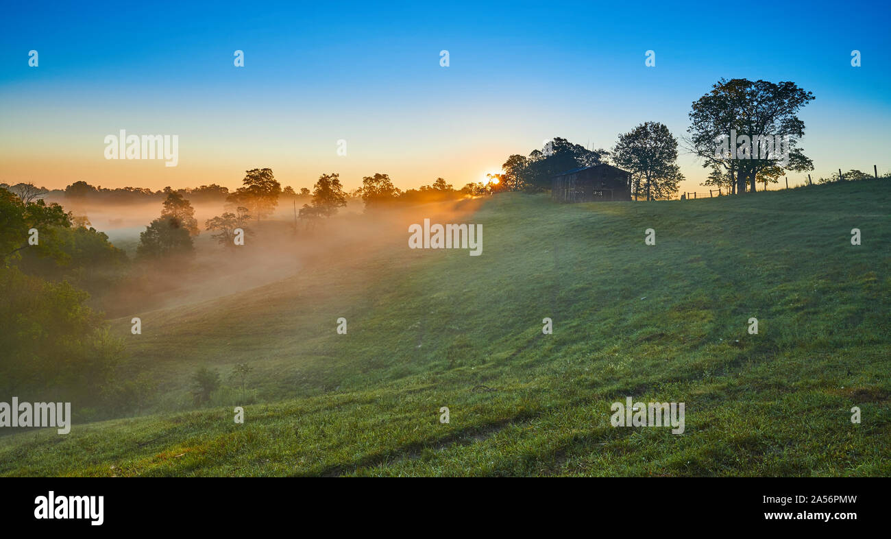 Farm at Sunrise with Fog Stock Photo - Alamy