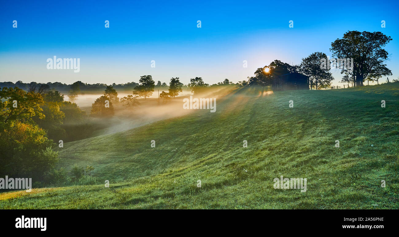 Farm at Sunrise with Fog Stock Photo - Alamy