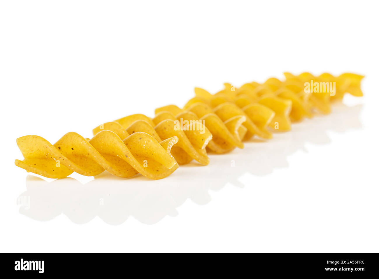 Lot of whole dry brown wholegrain fusilli isolated on white background ...