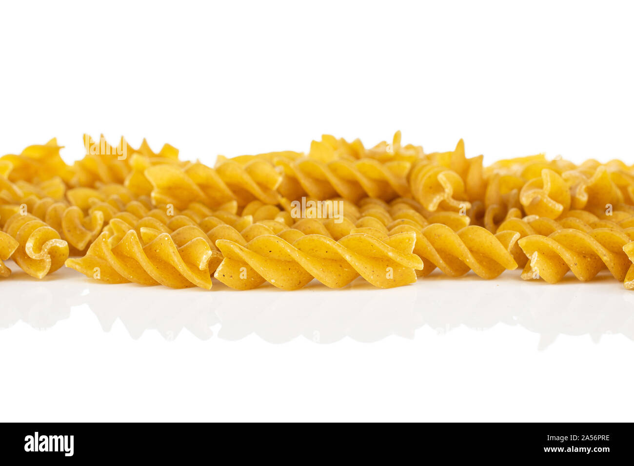 Lot of whole dry brown wholegrain fusilli isolated on white background ...
