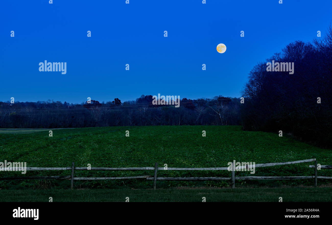 Super Moon Rising Over Field with Fence Stock Photo - Alamy