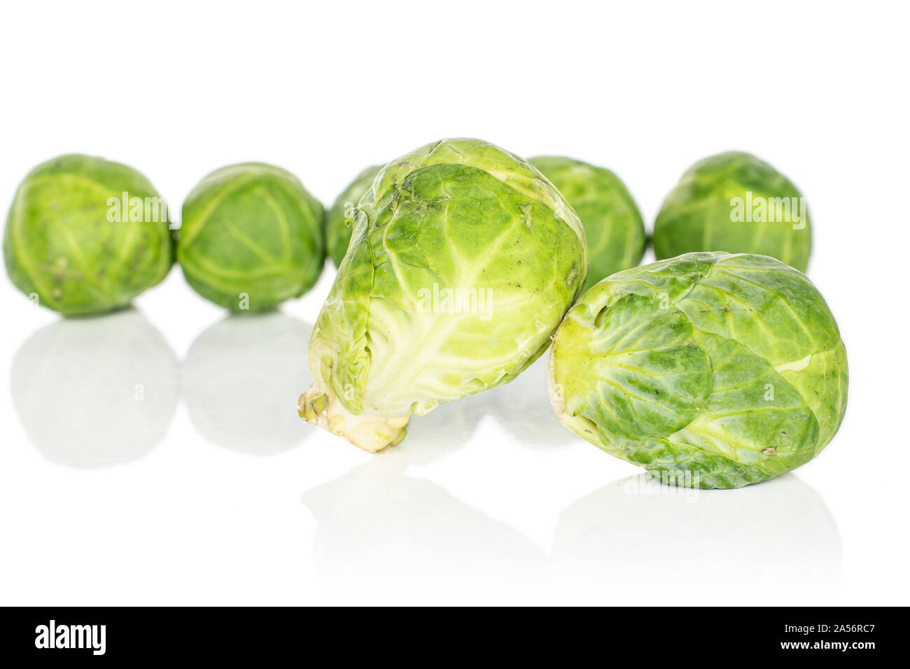 Group of seven whole fresh green brussels sprout isolated on white ...