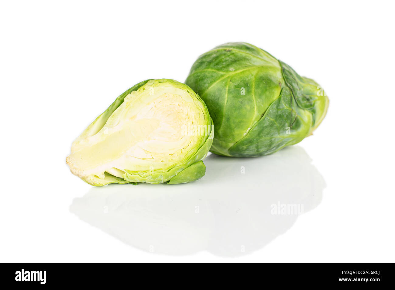 Group of one whole one half of fresh green brussels sprout isolated on ...