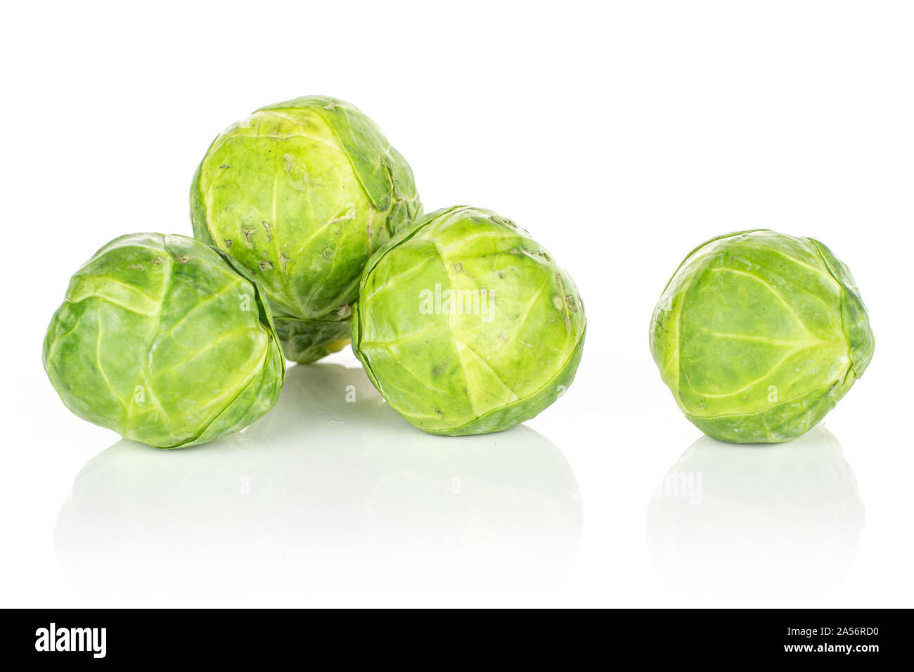 Group of four whole fresh green brussels sprout heap isolated on white ...