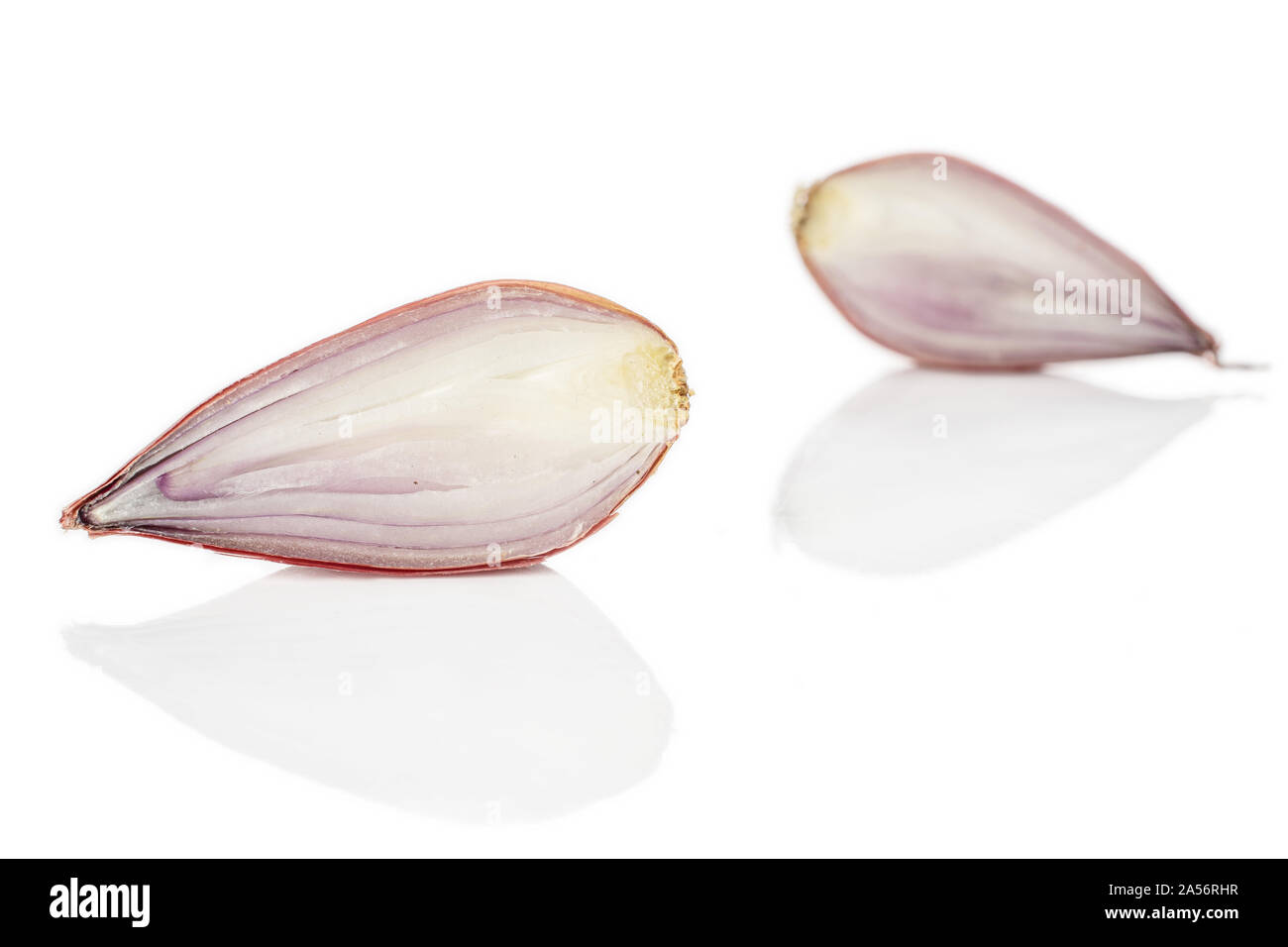 Group of two halves of fresh brown shallot isolated on white background ...