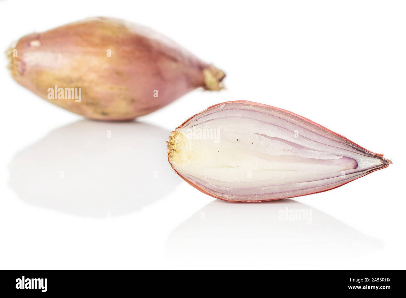 Group of one whole one half of fresh brown shallot isolated on white ...