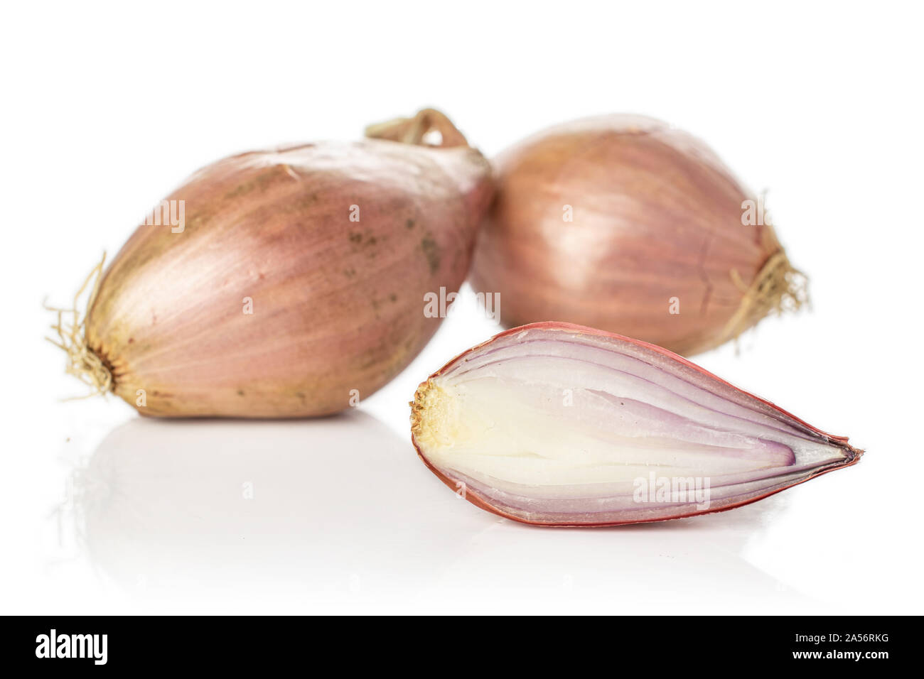 Group of two whole one half of fresh brown shallot isolated on white ...