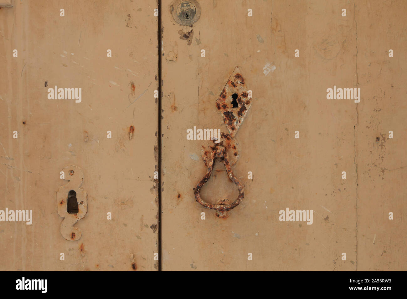 Very old rusty doors lock and handle on yellow doors Stock Photo - Alamy