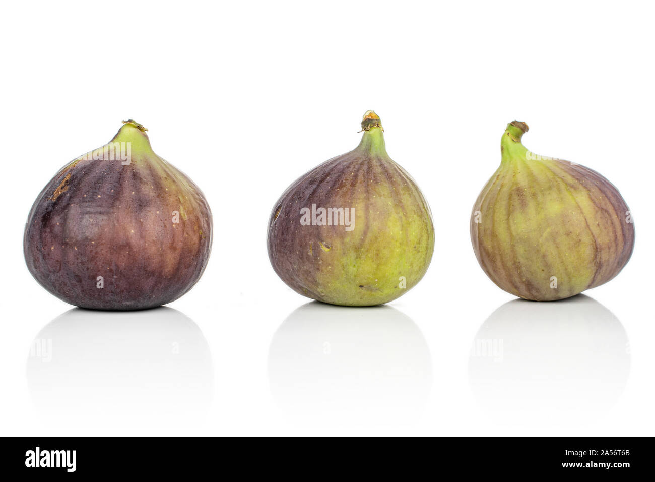 Group of three whole sweet purple fig isolated on white background ...