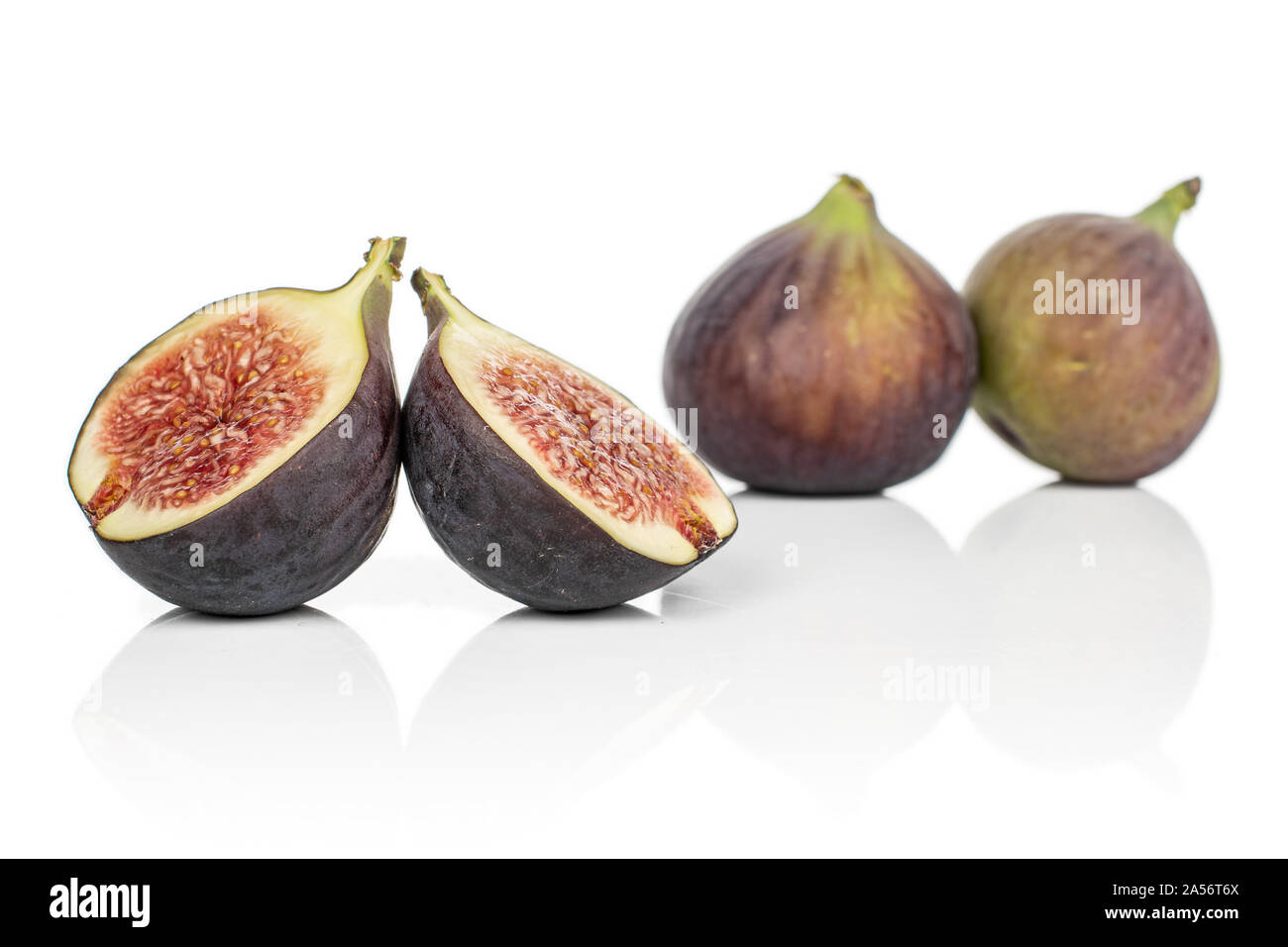 Group of two whole two halves of sweet purple fig isolated on white ...