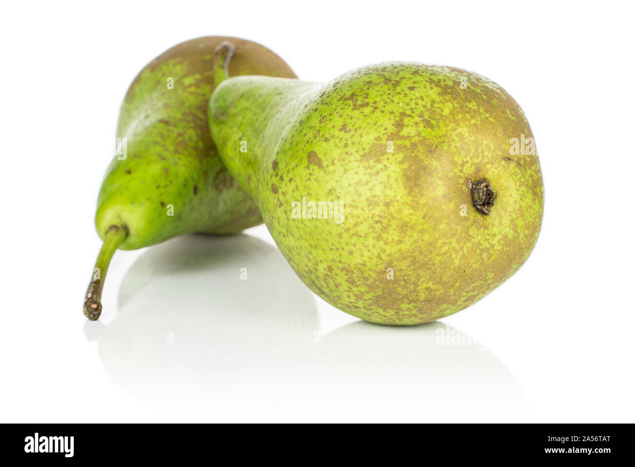 Group of two whole fresh green pear front focus isolated on white ...