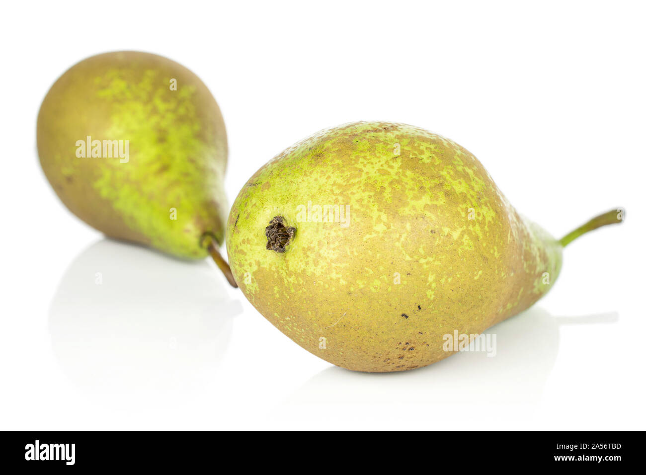 Group of two whole fresh green pear front focus isolated on white ...