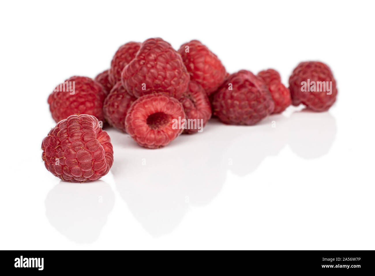 Lot of whole fresh red raspberry heap isolated on white background ...