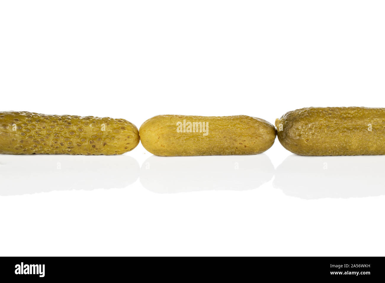 Group of three whole sour green pickle isolated on white background ...