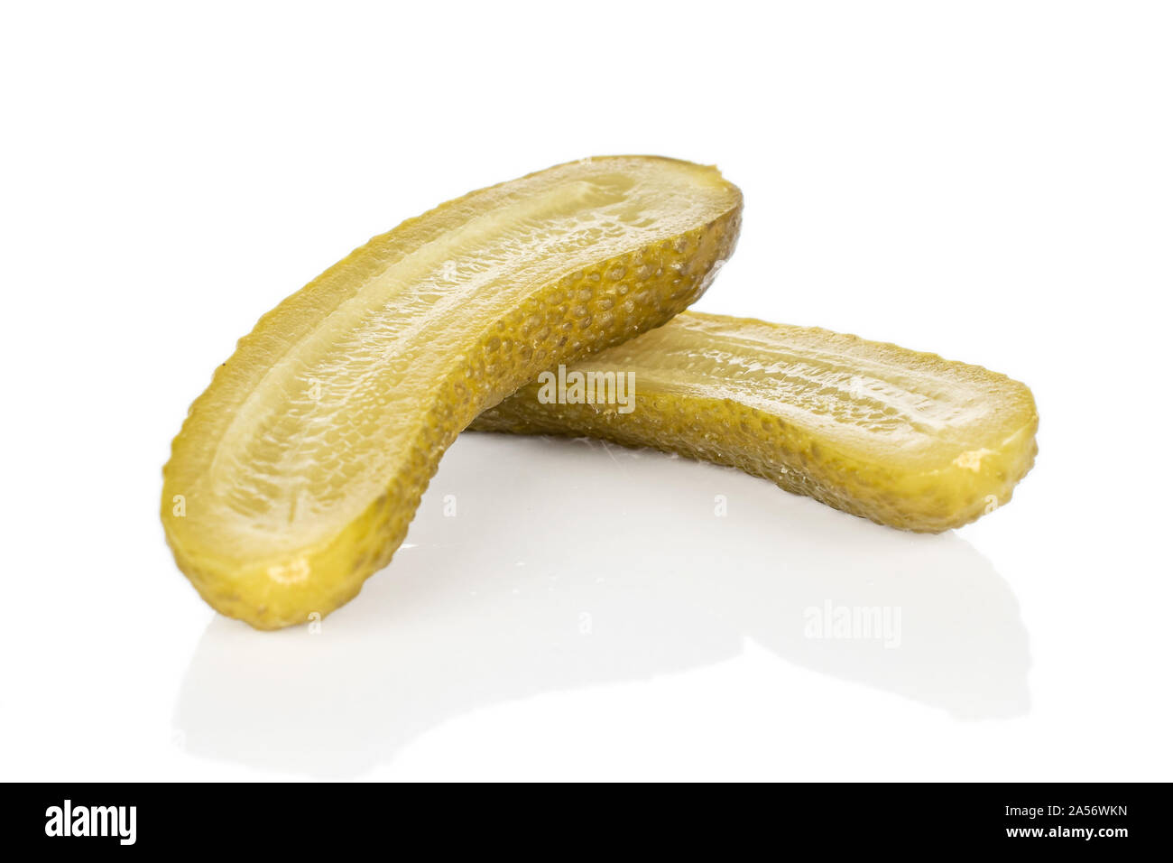 Group of two halves of sour green pickle isolated on white background ...