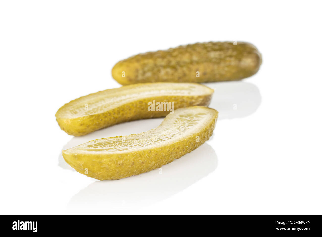Group of one whole two halves of sour green pickle isolated on white ...