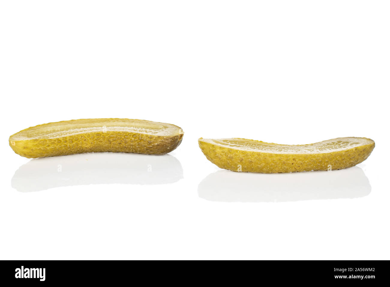 Group of two halves of sour green pickle isolated on white background ...