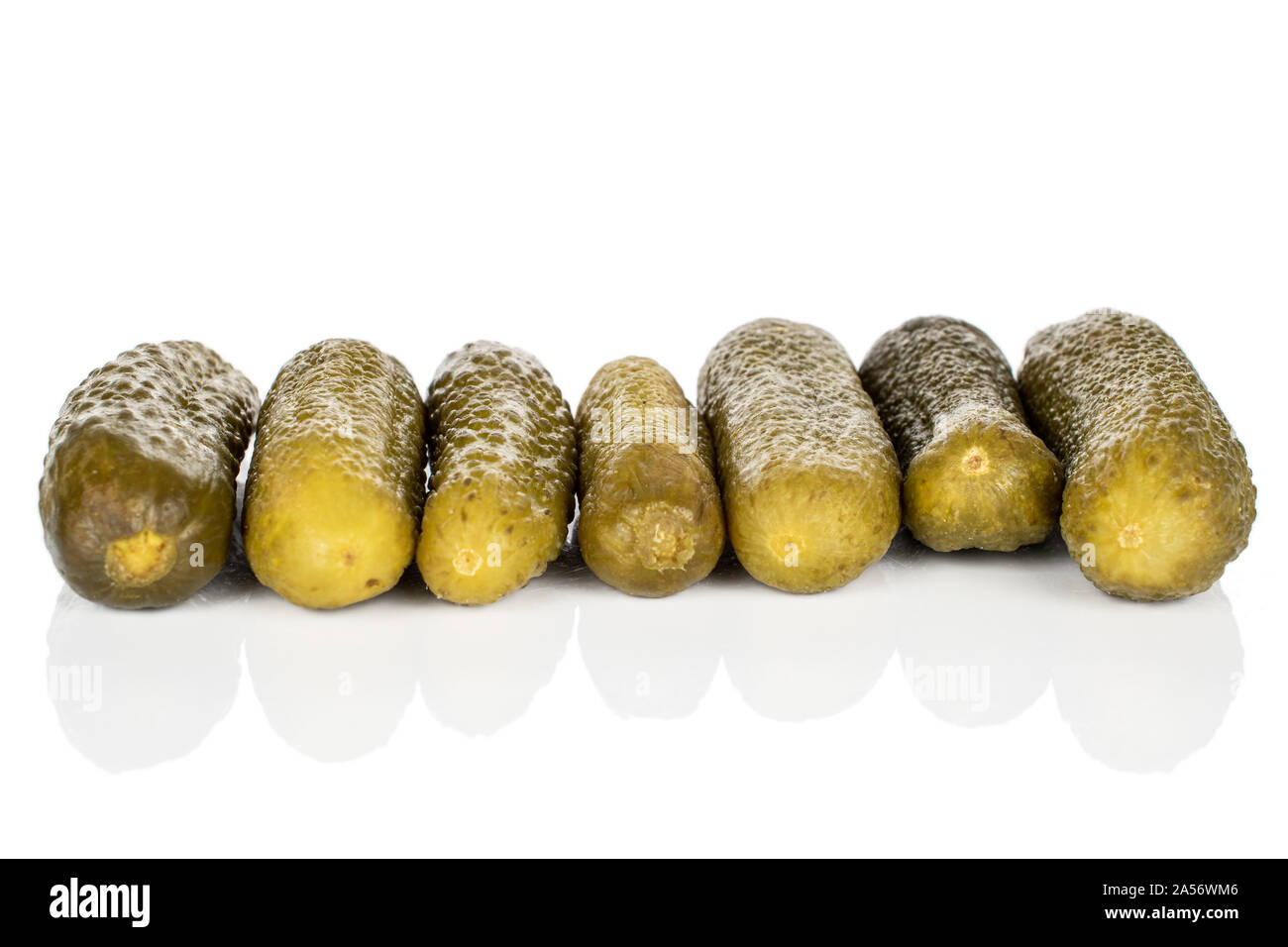 Group of seven whole sour green pickle isolated on white background ...