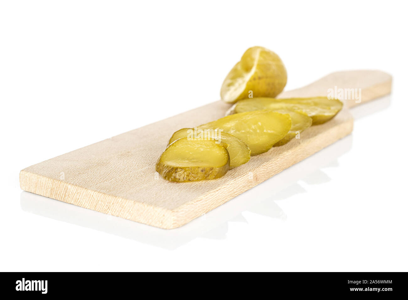 Group of five slices one piece of sour green pickle on wooden cutting ...