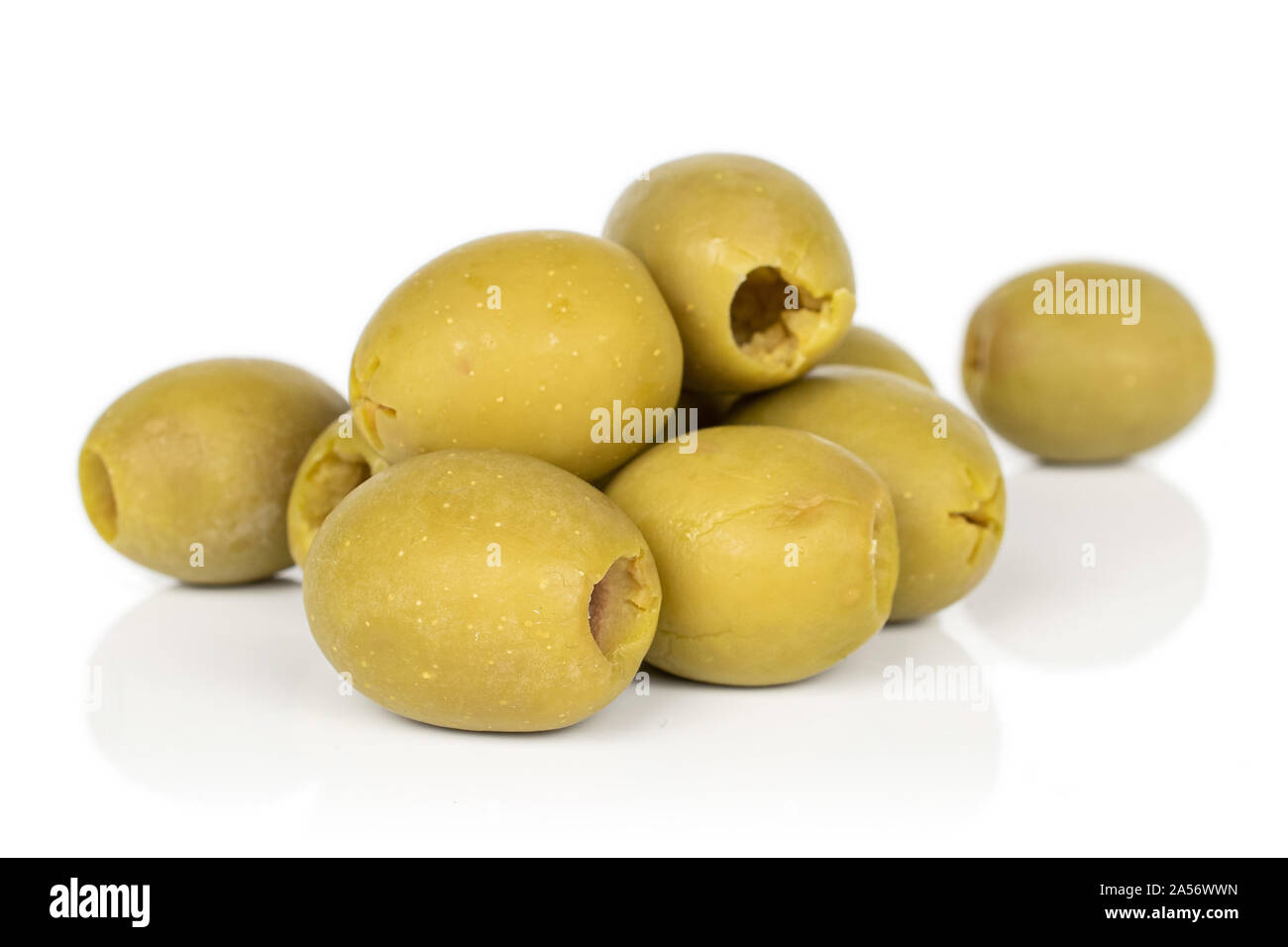 Group of nine whole marinated green olive isolated on white background ...