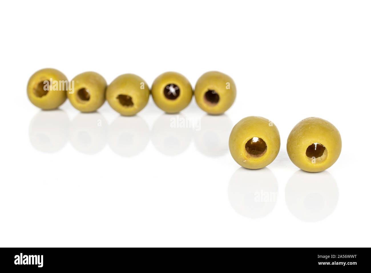 Group of seven whole marinated green olive isolated on white background ...