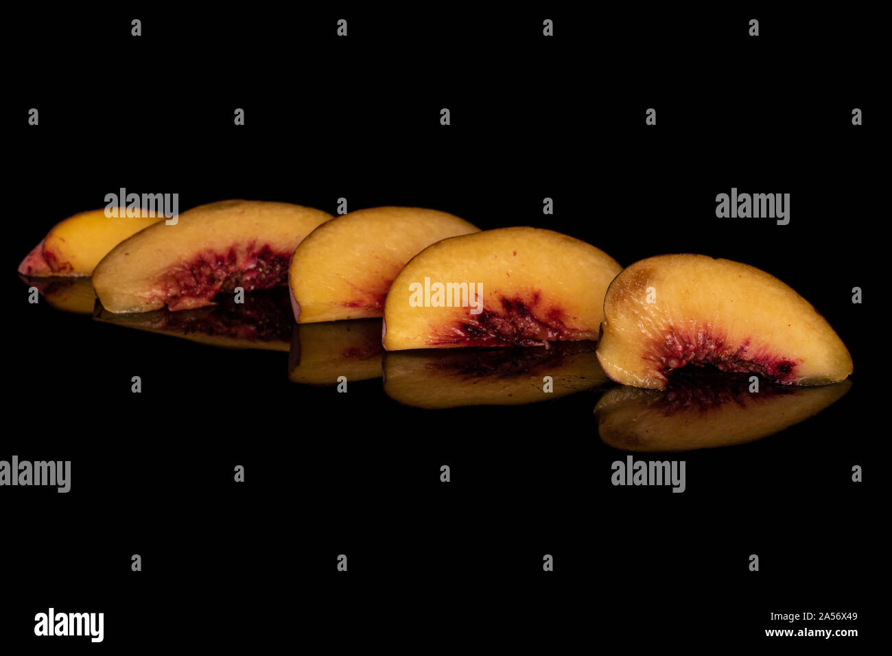 Group of five slices of sweet red peach isolated on black glass Stock ...