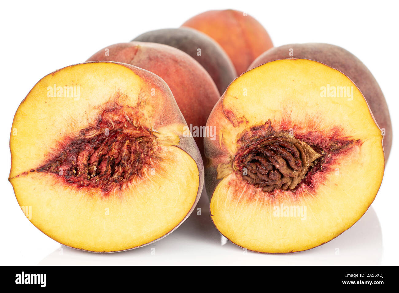 Group of four whole two halves of sweet red peach isolated on white ...