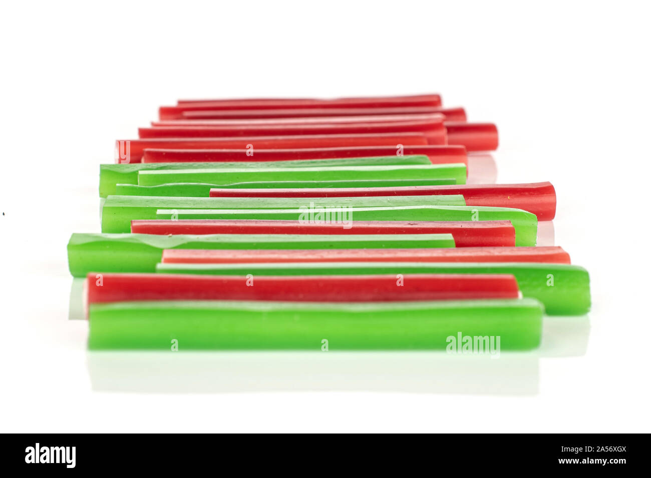 Lot of whole sweet stick candy in row isolated on white background ...