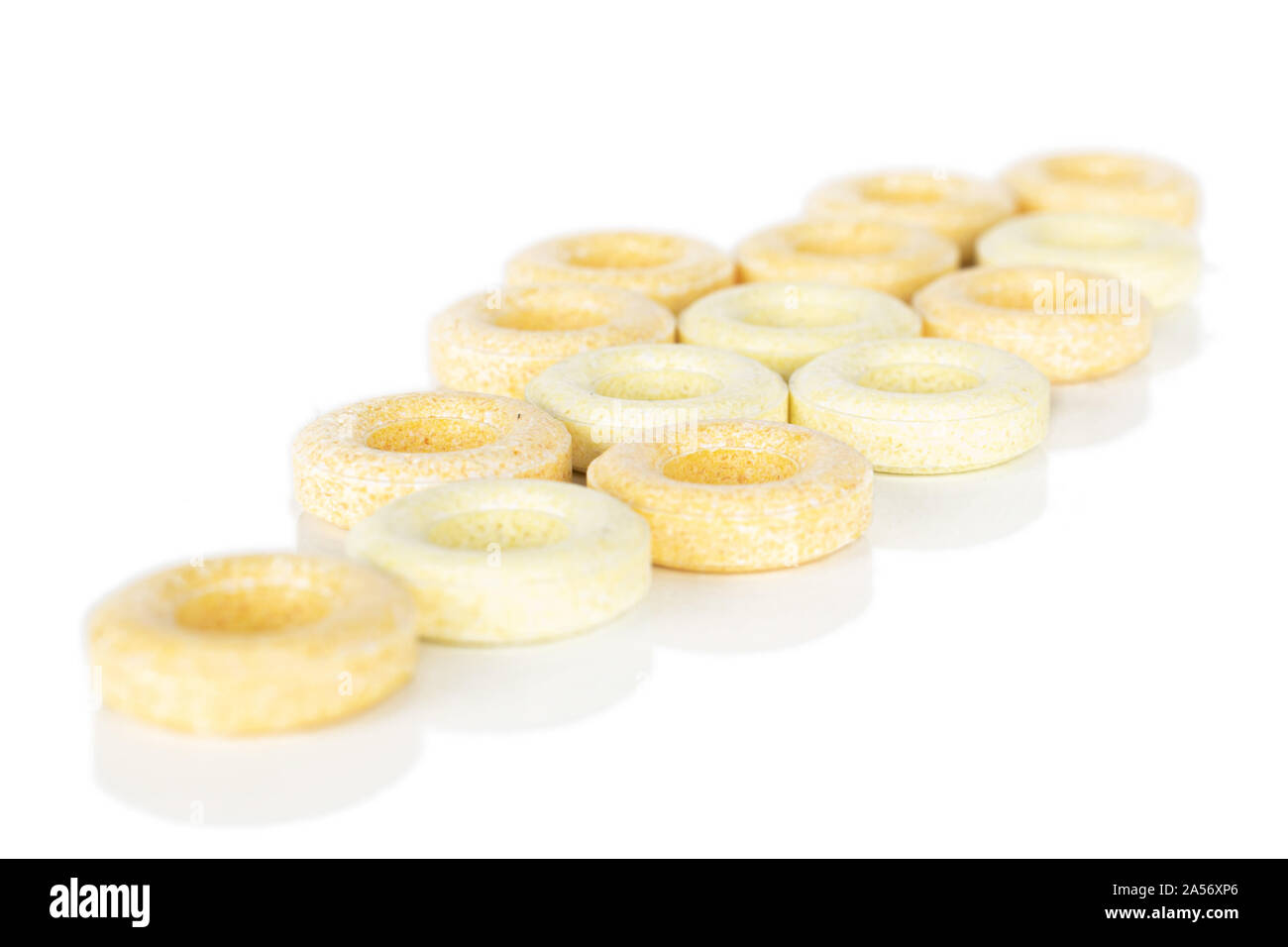 Lot of whole disordered round pale yellow candy isolated on white ...