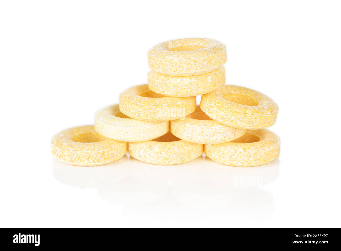 Group of nine whole round pale yellow candy isolated on white ...
