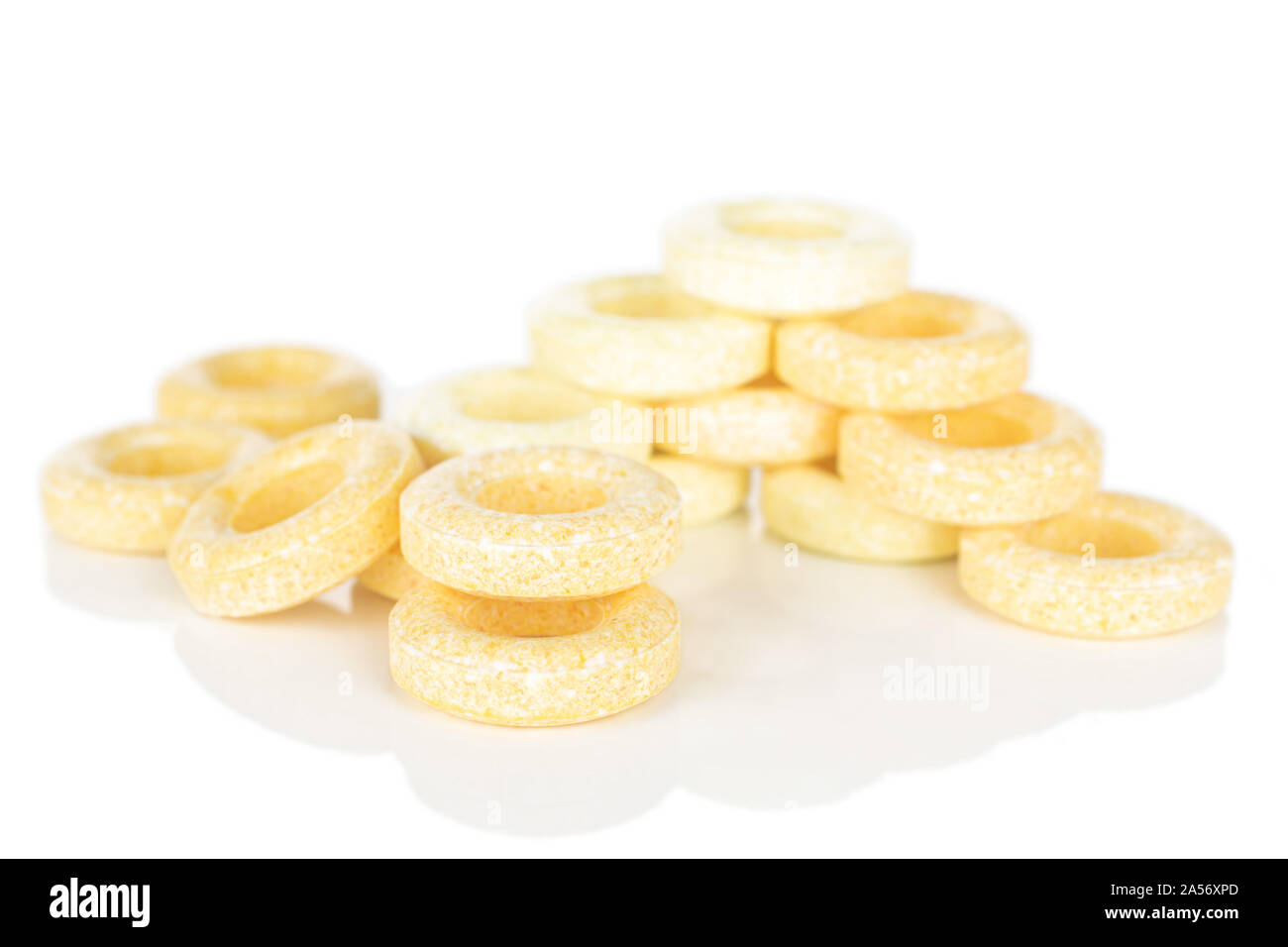 Lot of whole folded round pale yellow candy isolated on white ...