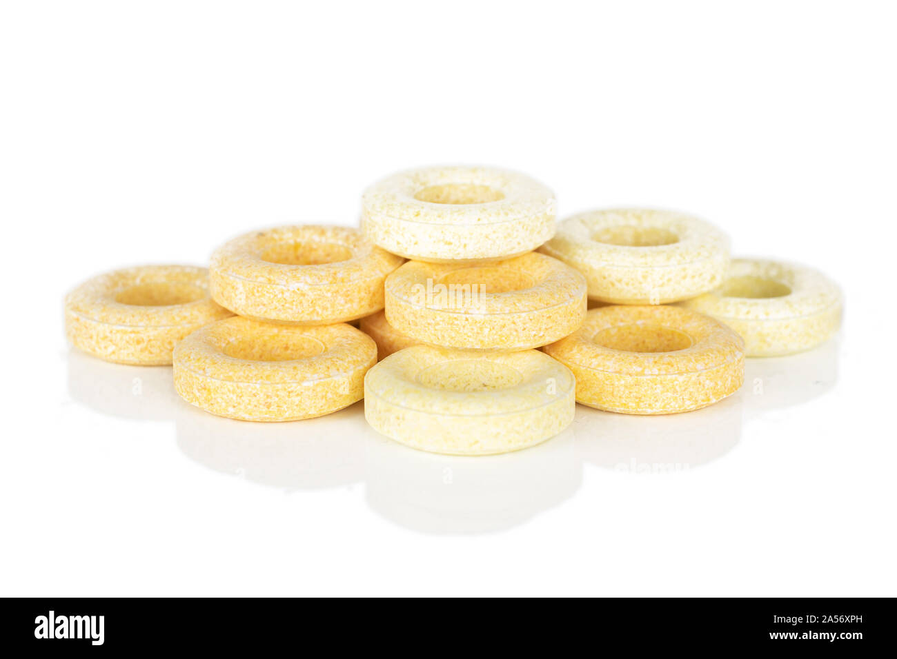Lot of whole round pale yellow candy pyramid isolated on white ...