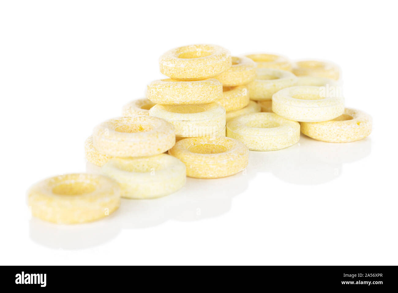 Lot of whole round pale yellow candy heap isolated on white background ...