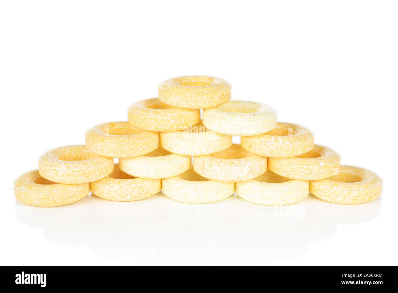 Lot of whole round pale yellow candy pyramid isolated on white ...