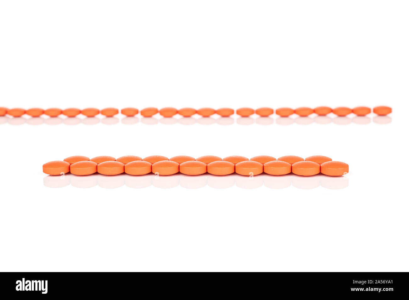 Lot of whole arranged orange tablet pharmacy isolated on white ...
