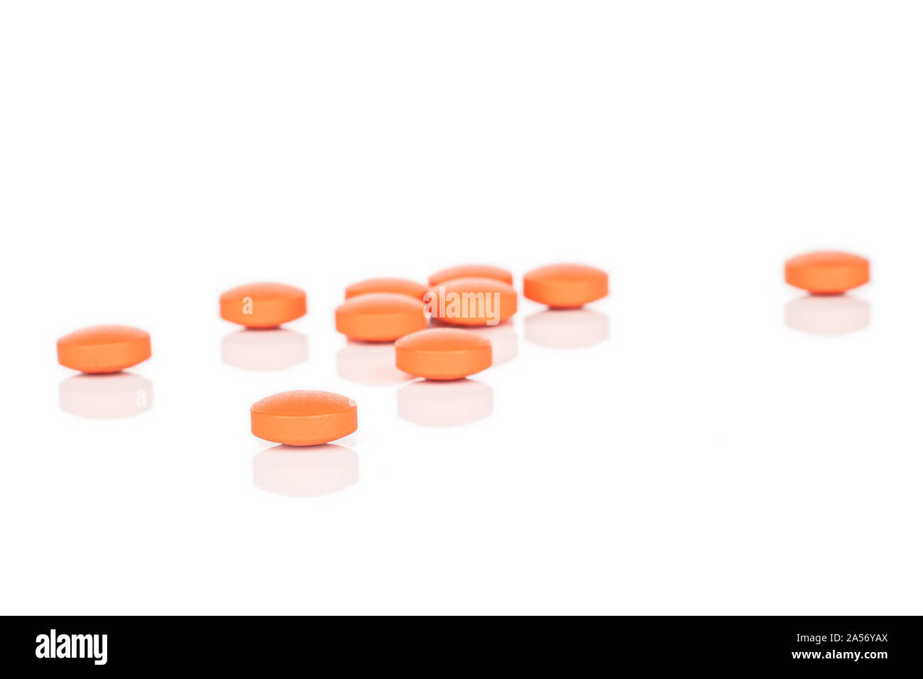 Group of nine whole orange tablet pharmacy isolated on white background ...