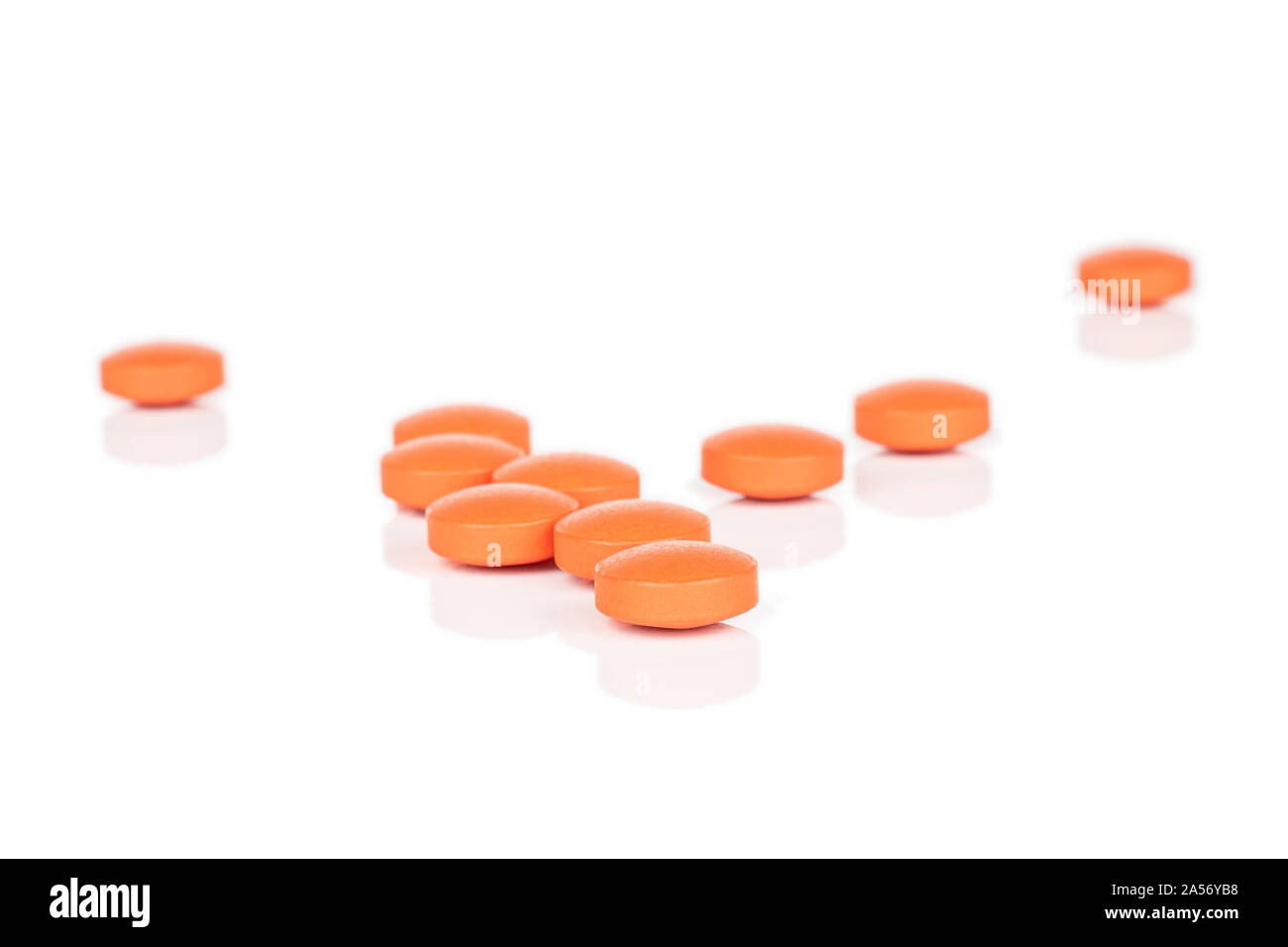Group of ten whole orange tablet pharmacy isolated on white background ...