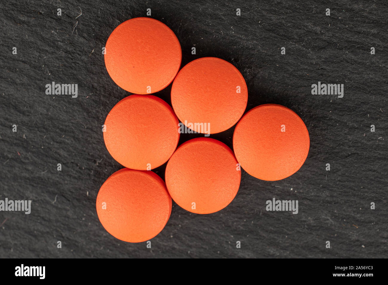 Group of six whole orange tablet pharmacy flatlay on grey stone Stock ...