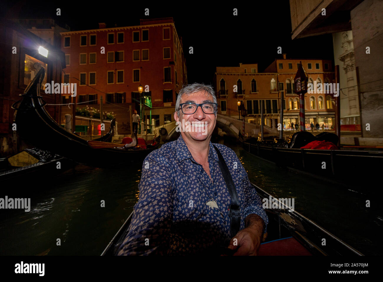 happy smiling tourist in Venice Gondola channels tour at night Stock ...