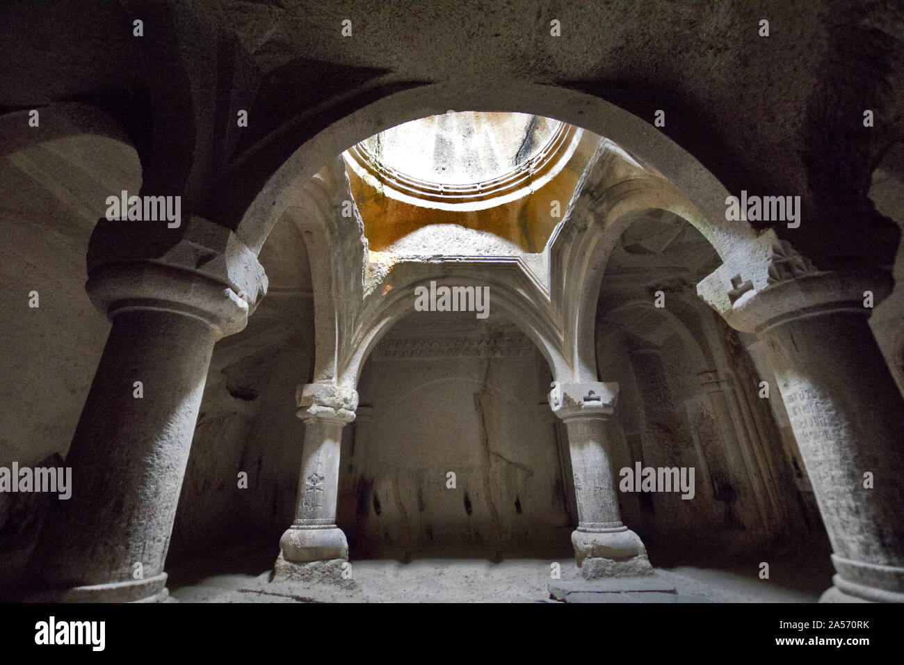 Geghard, Armenia: Cave Monastery with four columns Stock Photo - Alamy