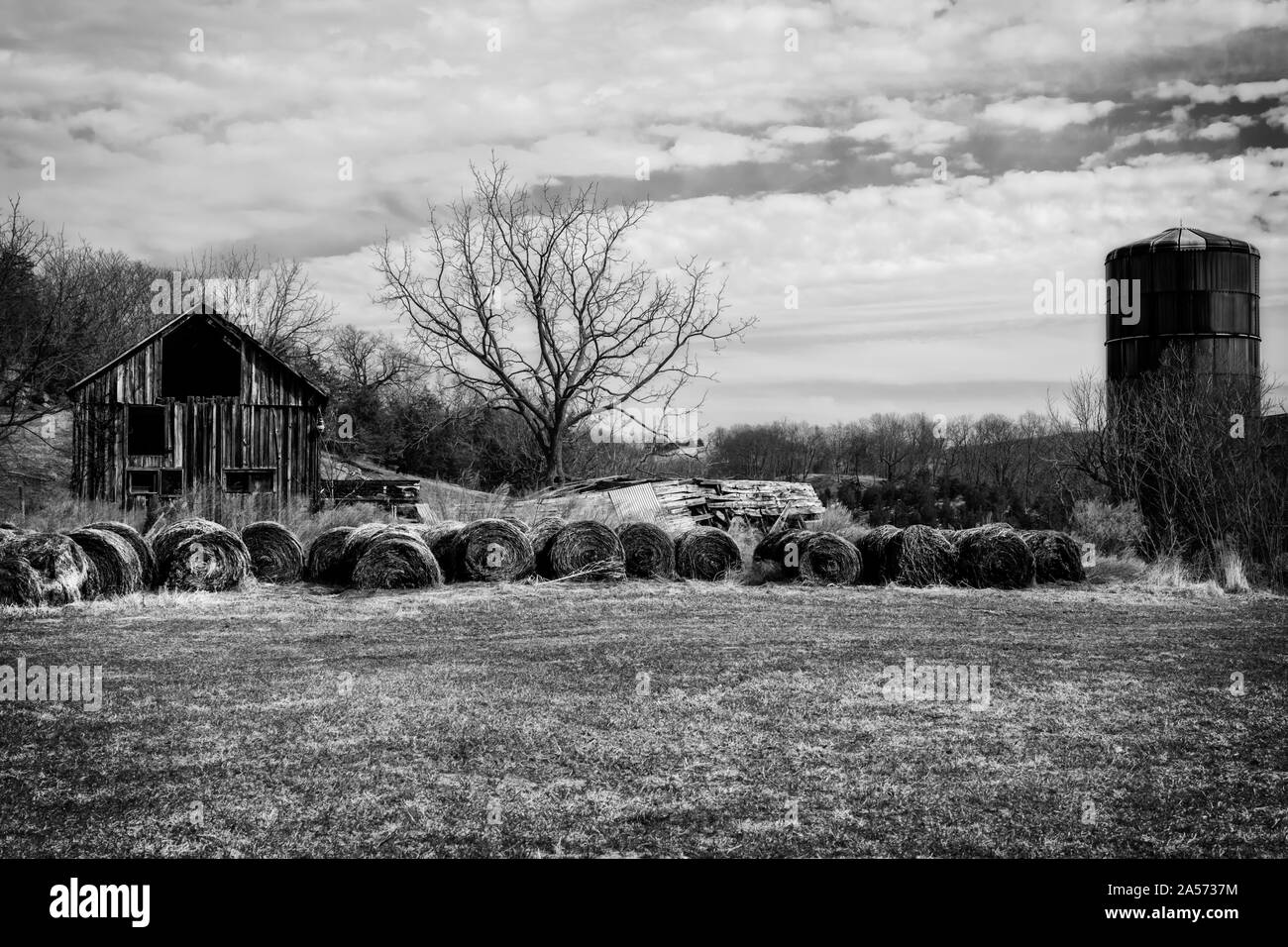 Abandoned farm with silo and hay bales Stock Photo - Alamy