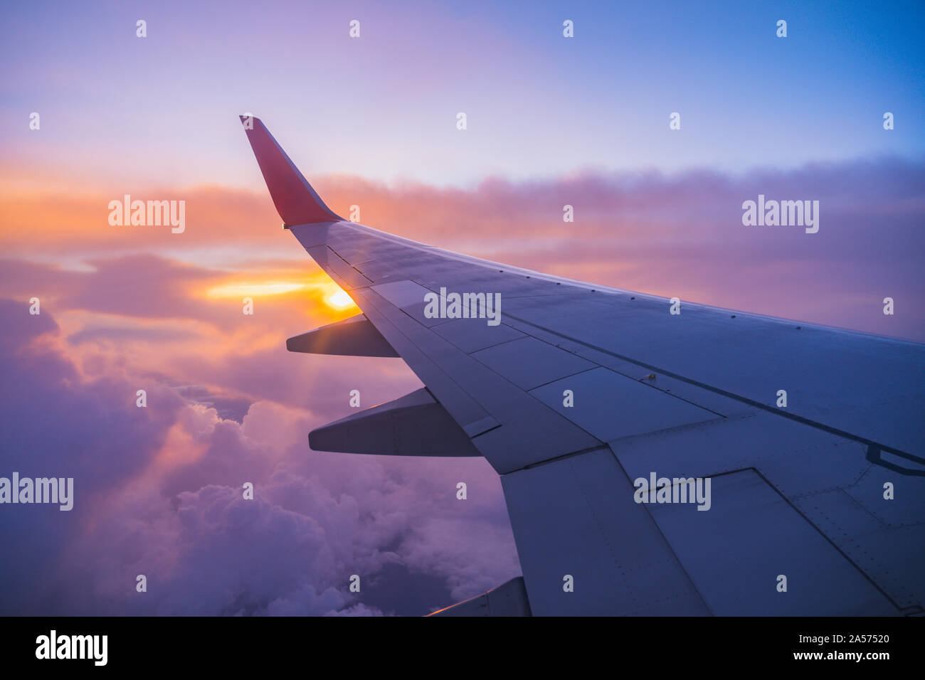 Beautiful sunset, sky on the top view, airplane flying view from inside ...
