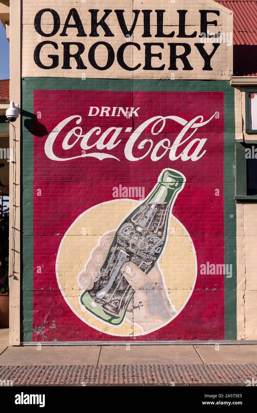 Vintage Coca-Cola sign on an outside wall of a grocery store in ...