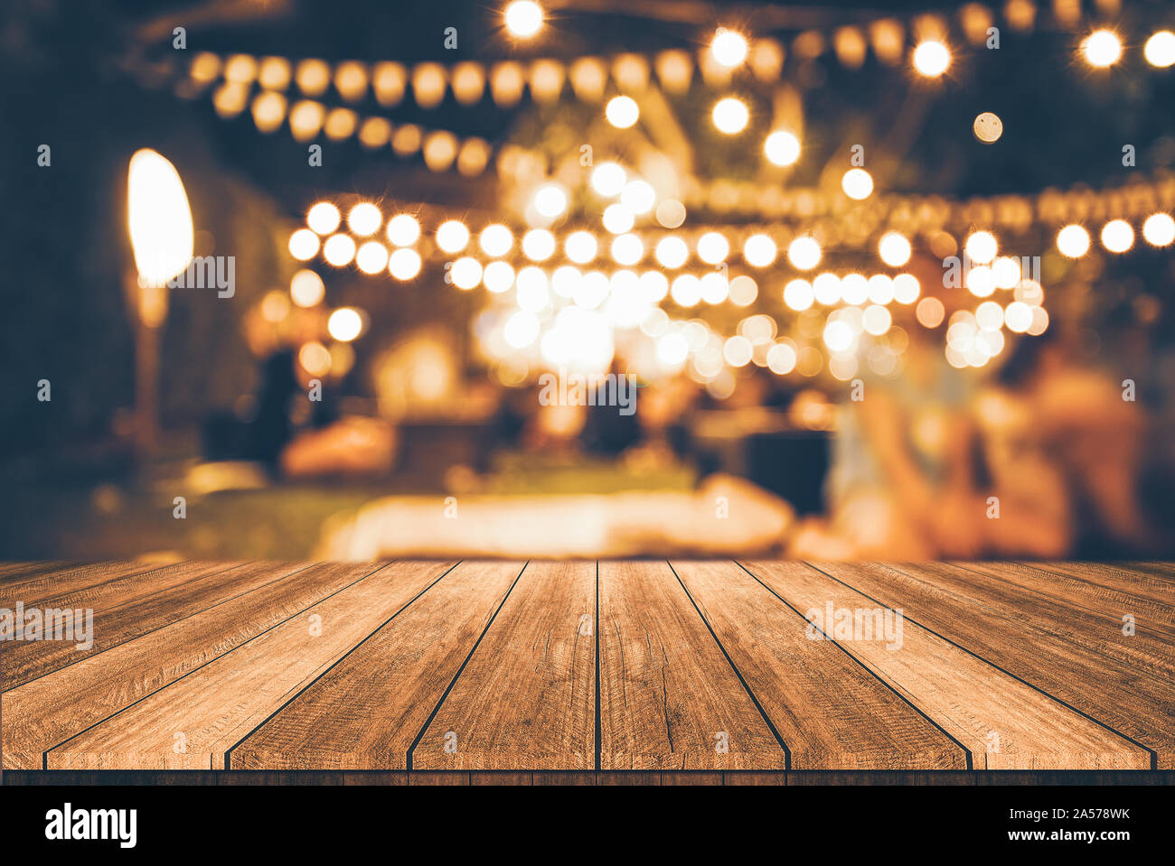 wooden table in front of abstract blurred restaurant lights background ...