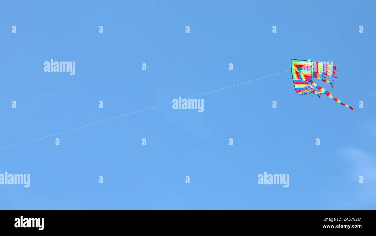 high kite flying on the blue sky and copy space to write some text ...