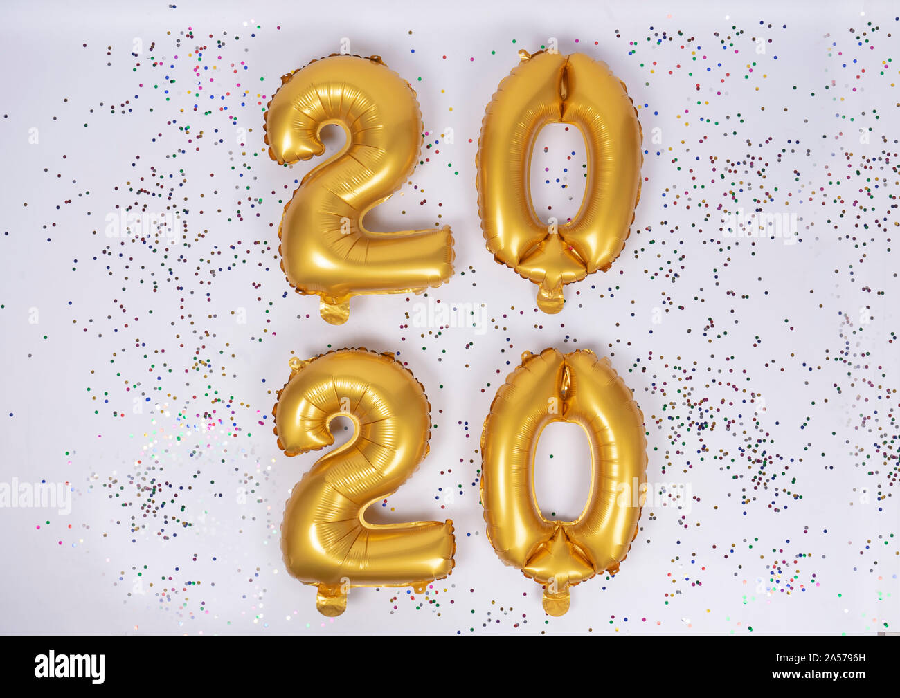 2020 number of frustrated gold balloons isolated with colored confetti ...