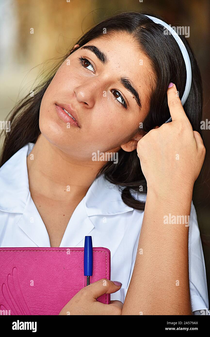 Cute Colombian Girl Student Thinking With Notebook Stock Photo - Alamy