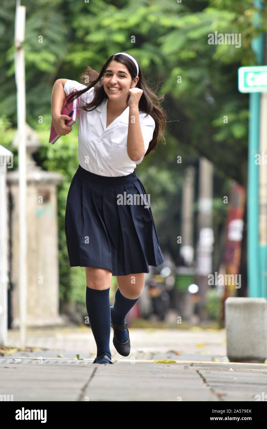 Cute Girl Student Running With Notebook Stock Photo - Alamy