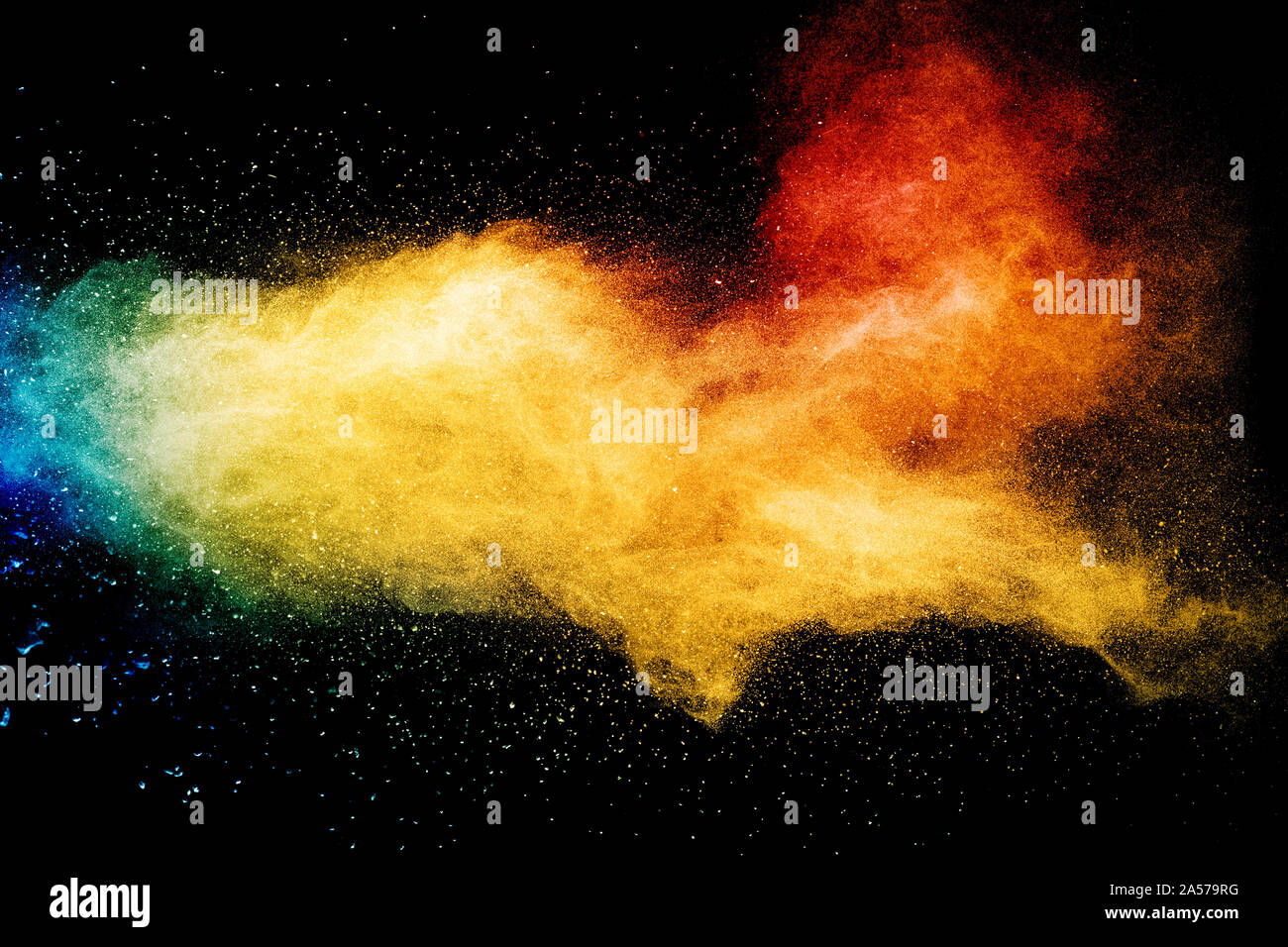 Yellow red blue powder explosion cloud on black background. Freeze ...